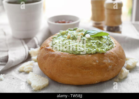 Bread loaf filled with tasty spinach sauce on table Stock Photo - Alamy