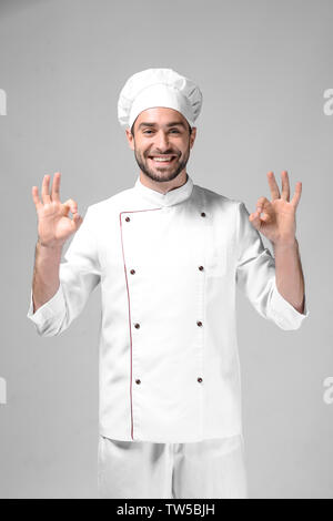 Young male chef on light background Stock Photo - Alamy