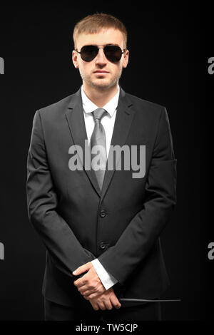 Handsome security guard on dark background Stock Photo - Alamy