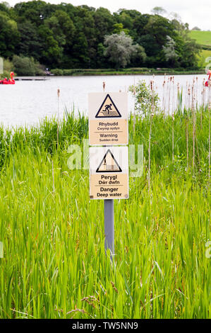 danger deep water sign board on a post Pond with lifebelt Glastonbury ...