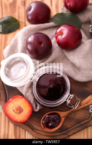 Tasty plum jam in jar and plums on wooden table close-up Stock Photo ...
