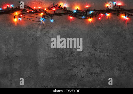 Christmas lights glowing on grey background Stock Photo - Alamy