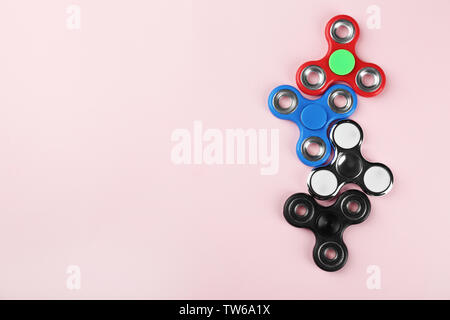 Different modern spinners on color background, top view Stock Photo - Alamy