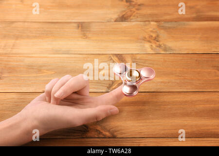 Woman rolling modern spinner on grey background Stock Photo - Alamy
