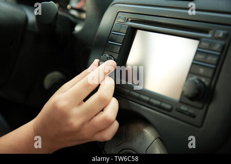Woman tuning radio in car Stock Photo - Alamy
