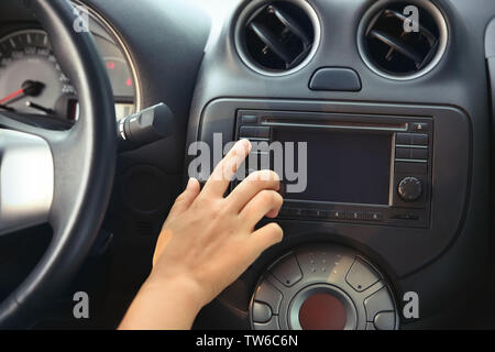 Woman tuning radio in car, closeup Stock Photo - Alamy
