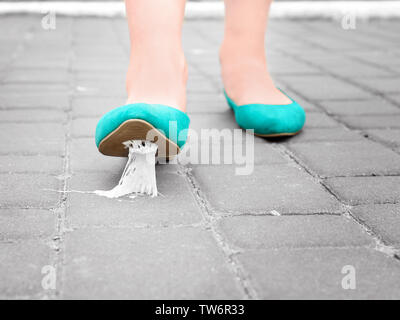 Female foot stuck into chewing gum on street. Concept of stickiness ...