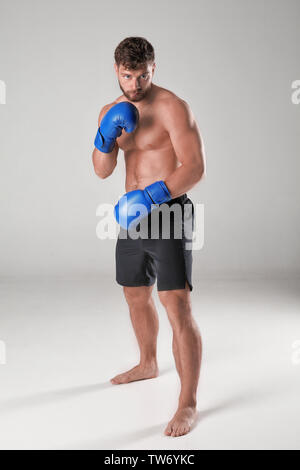 Sporty male boxer on grey background Stock Photo - Alamy