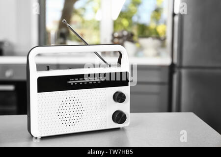Stylish radio receiver on kitchen table Stock Photo - Alamy