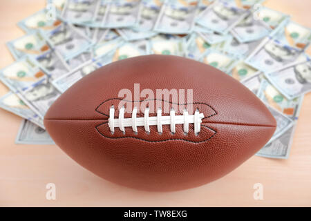 Football ball and money on table Stock Photo - Alamy