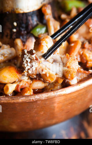 Charcoal fire frog pot field chicken meal Stock Photo - Alamy