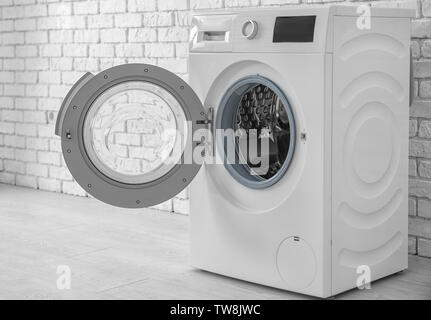 Modern washing machine near brick wall Stock Photo - Alamy