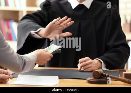 Male judge refusing to take bribe from woman, closeup Stock Photo - Alamy