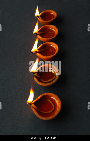 Diwali diyas burning in a row Stock Photo - Alamy