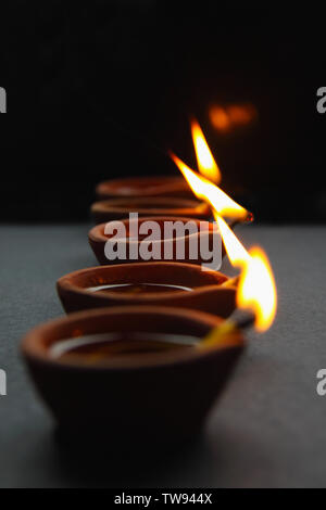 Diwali diyas burning in a row Stock Photo - Alamy