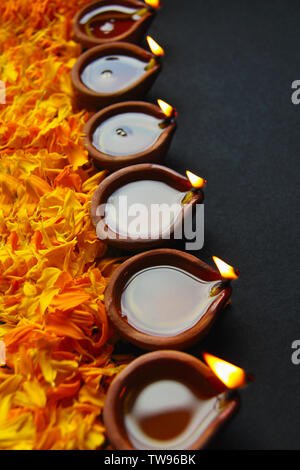 Diwali diyas burning in a row Stock Photo - Alamy