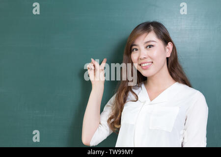 beautiful girl teacher with green blackboard Stock Photo - Alamy