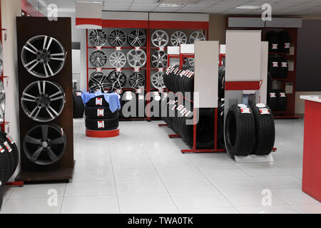 Modern store with alloy wheels and tires, indoors Stock Photo - Alamy