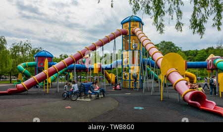 Families enjoying Saturday leisure time in a playground area of the ...