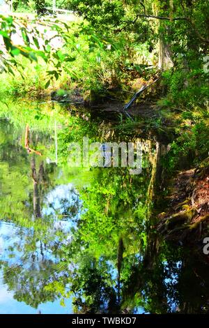 Still reflective hot spring water near Blue Lagoon, Iceland with steam ...