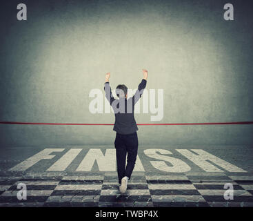 Woman crossing the finish line Stock Photo - Alamy
