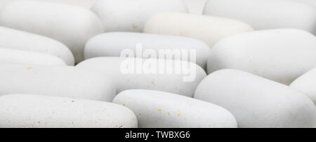 background of white smooth stones of elongated shape Stock Photo - Alamy