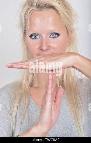 Break time hand gesture on a white background Stock Photo - Alamy