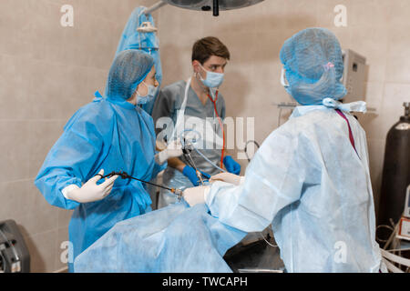 veterinarian or doctors doing surgery in the clinic. medicine, pet ...