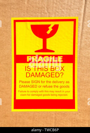 Courier with damaged cardboard box on yellow background. Poor quality ...