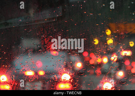 rain droplets on car windshield, traffic in city Stock Photo - Alamy
