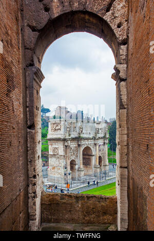Archway in Colosseum with Arch of Constantine, the world known landmark ...