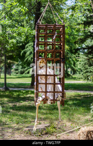 Head in a cage hanging from the ceiling of a torture chamber in the ...
