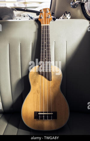 Small instrument - light brown ukulele on beautiful wooden table Stock ...