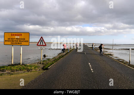 The 'Tide Times' warning notices before crossing the causeway to Holy ...