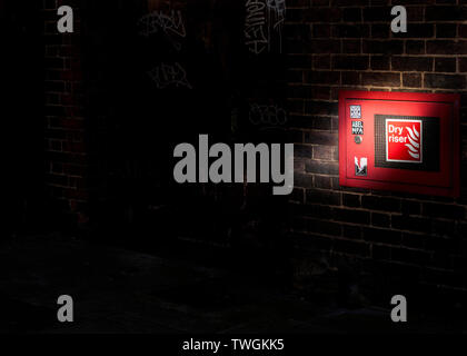 Dry riser red inlet box and sign at wall Stock Photo - Alamy