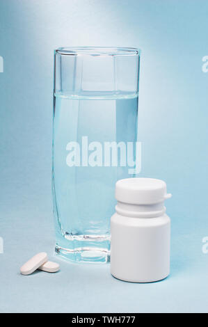 Blank plastic vitamin bottle and pills on grey background Stock Photo ...