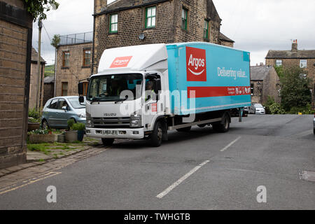Argos home delivery van in a street with rear door open and man ...