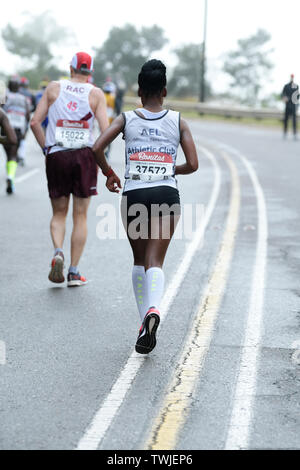 Durban, South Africa, woman runner watching volunteer first aider ...