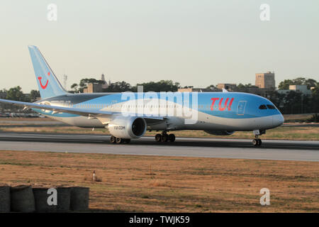 TUI Airways Boeing 787-8 Dreamliner at Manchester Airport as a family ...