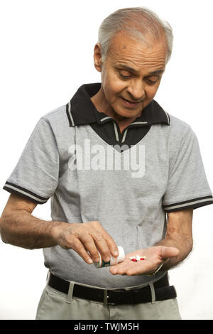 Old man pouring prescription medication into hand Stock Photo - Alamy