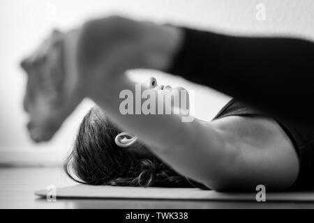 Young woman in Samakonasana pose against floor window, rear view Stock ...