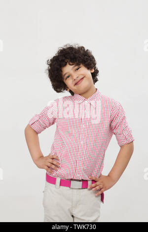 Boy with arms akimbo standing on rock in forest Stock Photo - Alamy