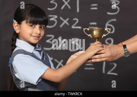 Girl being awarded trophy Stock Photo - Alamy