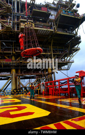 offshore worker transfer from platform to vessel by using crane bucket ...