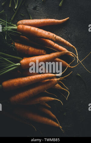 Fresh carrots, dark background. Food delivery concept, eco-friendly ...