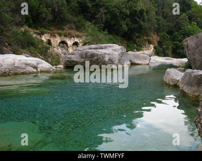 Blue river pool with ancient aqueduct behind Stock Photo - Alamy