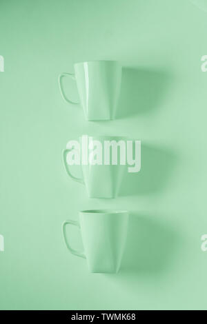 Row of three mugs isolated on white background Stock Photo - Alamy
