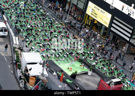 People participate in a mass yoga class during the "Times Square: Mind ...