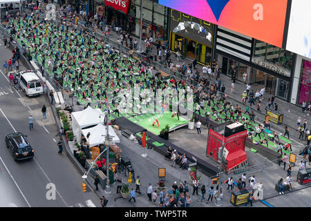 People participate in a mass yoga class during the "Times Square: Mind ...