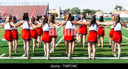 High school kickline team dancing at half time of a basketball game ...